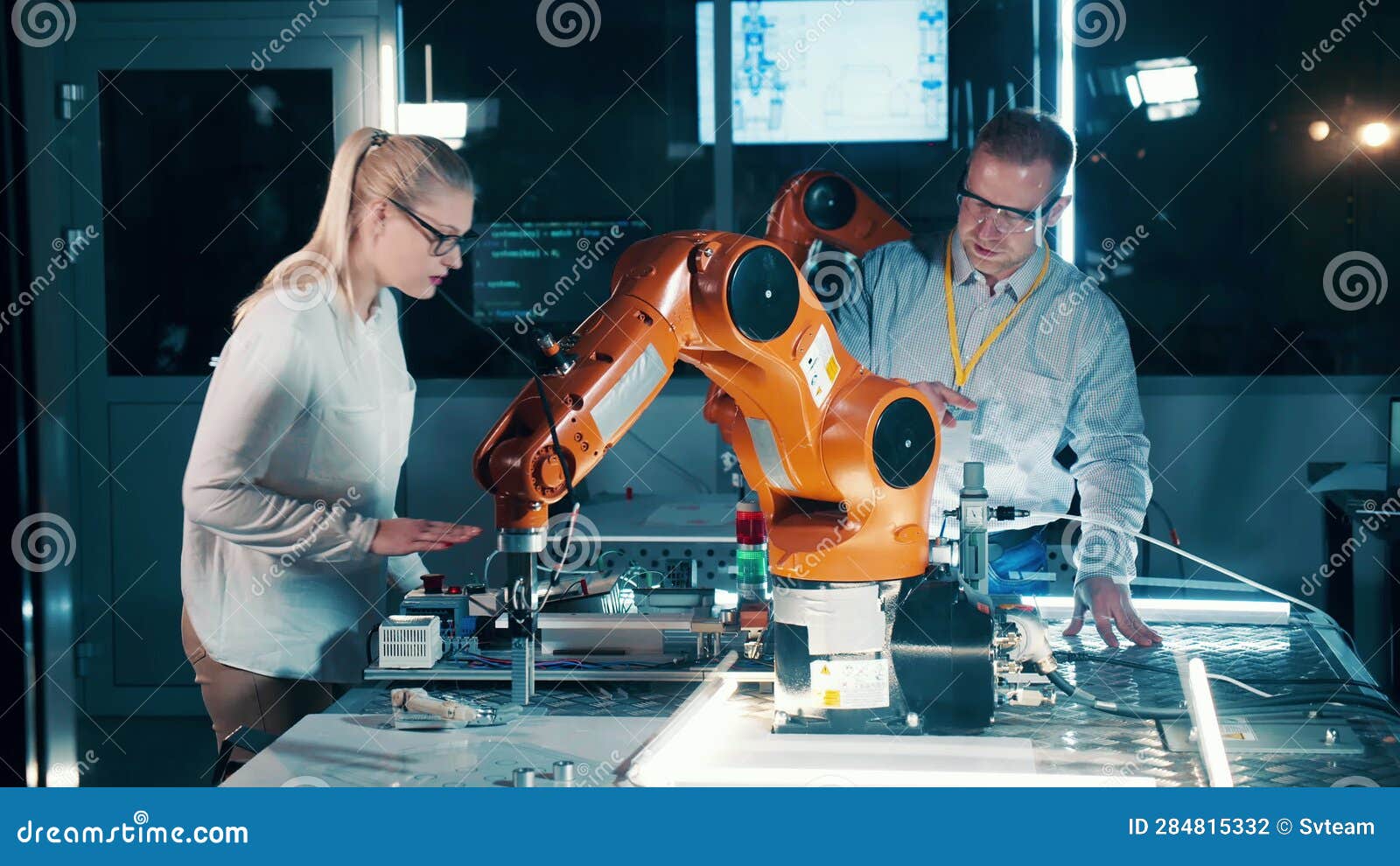 Robotics Technicians are Examining Robotic Devices in a Modern Lab ...