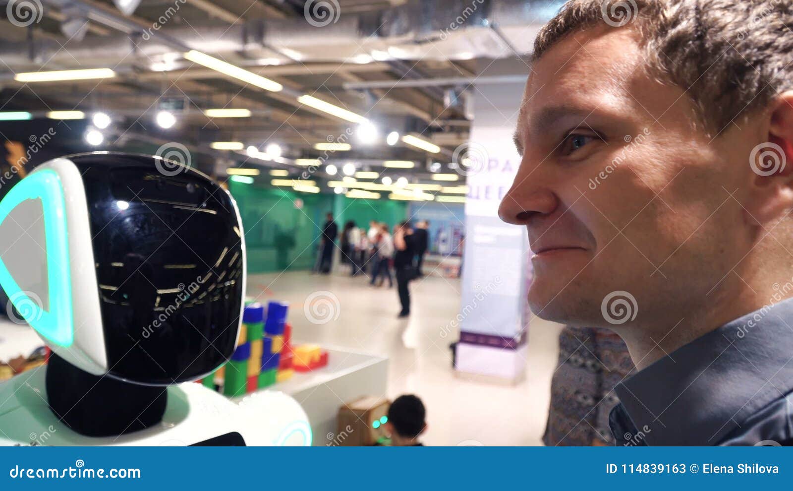 Robotics Technology. Guy Talk with Robot. Robot Head with Camera Scan ...