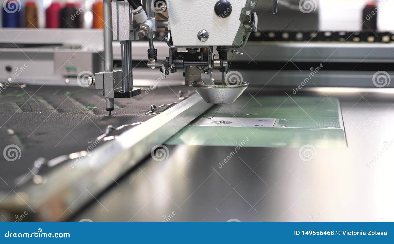 Robotics Works in Tailoring Production Line. Robot Sewing Machine Stock ...