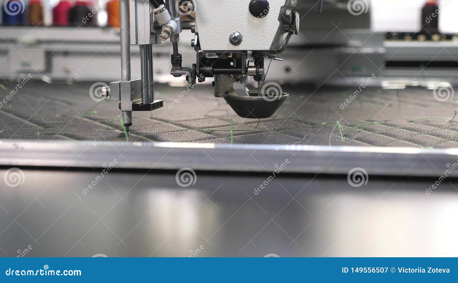 Robotics Works in Tailoring Production Line. Robot Sewing Machine Stock ...