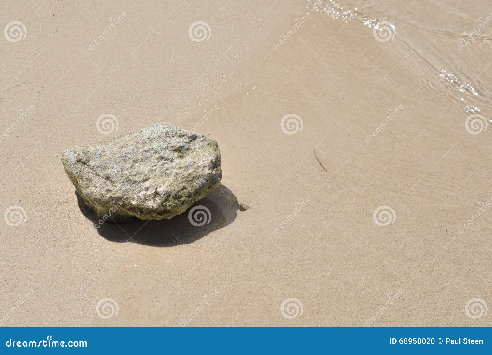Roca en la playa foto de archivo. Imagen de arena, agua - 68950020