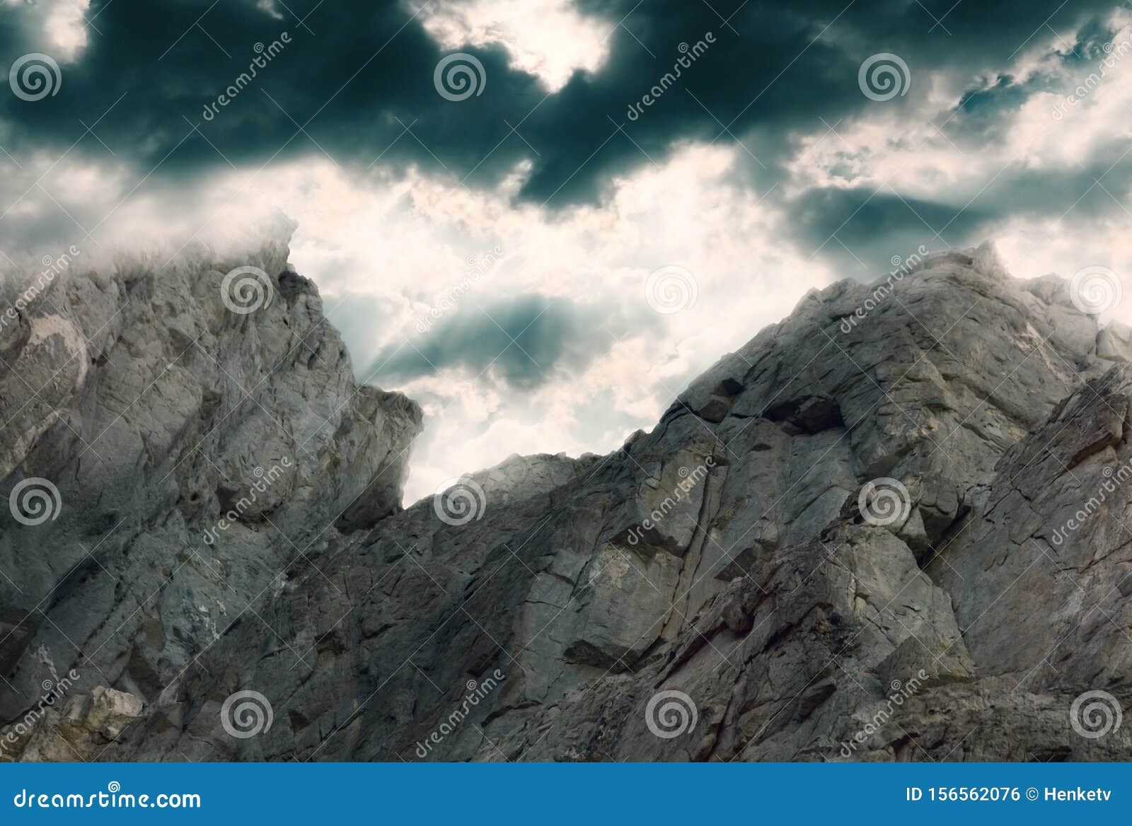 Rock Against a Dark Dramatic Sky with Clouds Stock Photo - Image of ...