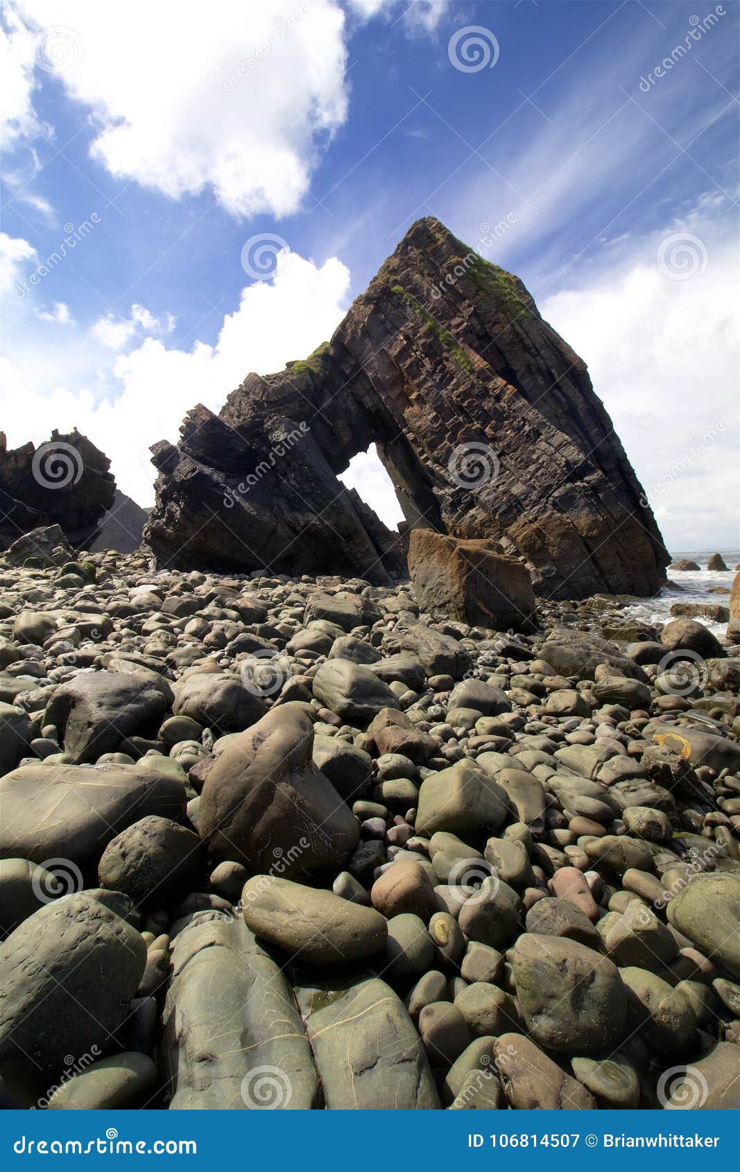 A rock arch on a beach stock image. Image of rock, erosion - 106814507