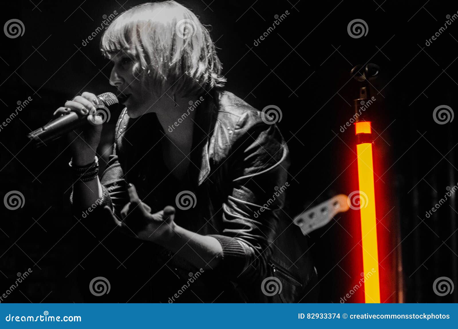 Rock Band Lead Singer Wearing Black Jacket And Wireless Microphone ...