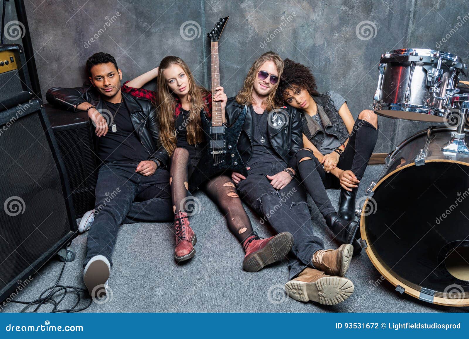 Rock Band Sitting on Floor while Resting after Rehearse Stock Photo ...