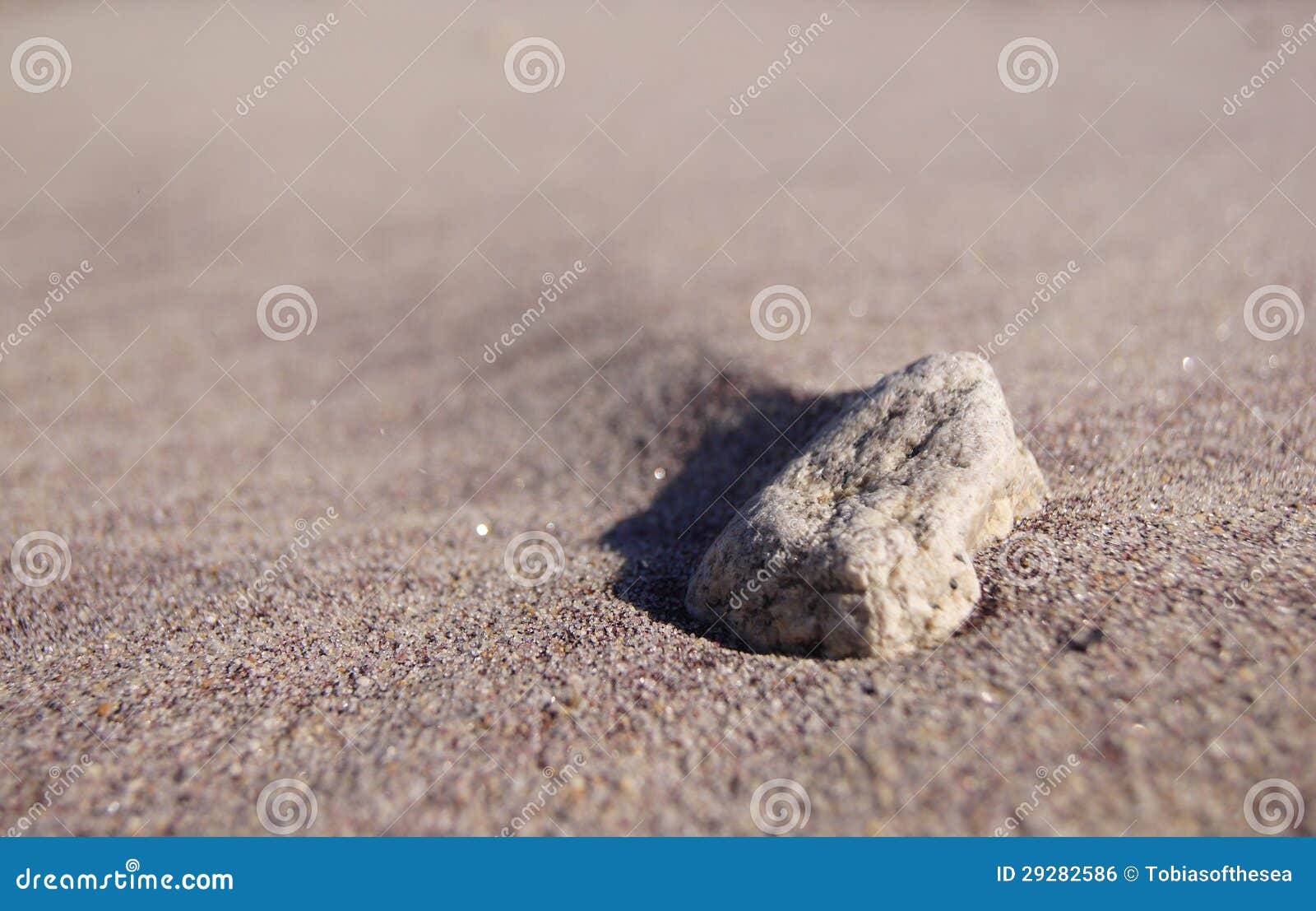 Rock in beach sand stock photo. Image of shadow, alone - 29282586
