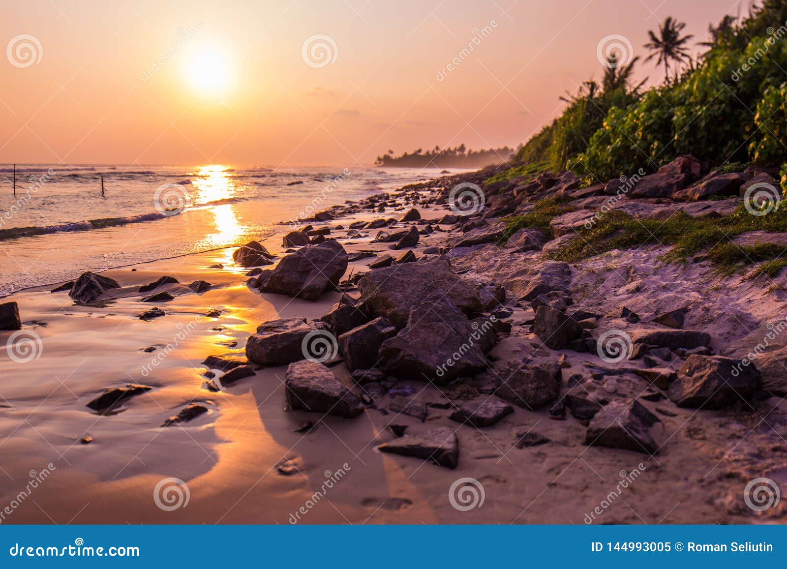 Rock beach at sunset stock image. Image of landscape - 144993005