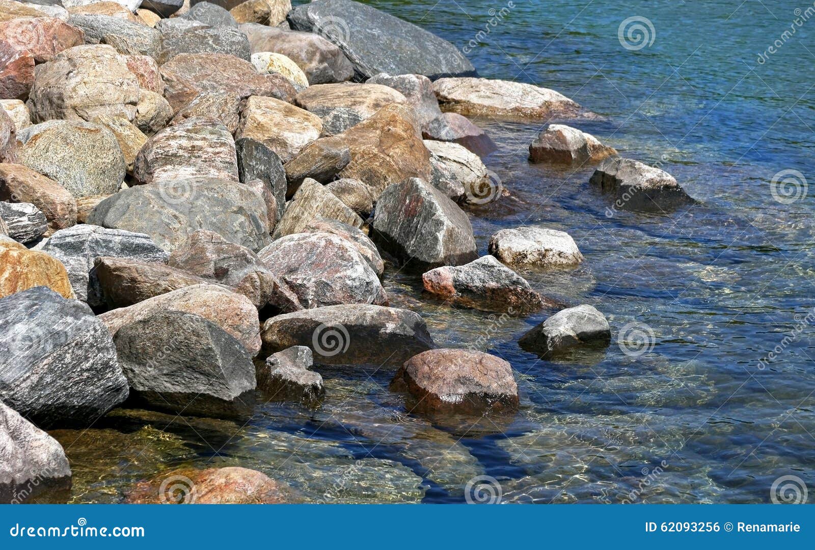 Rock Bed Along Shoreline of Clear Blue Lake Waters Stock Photo - Image ...