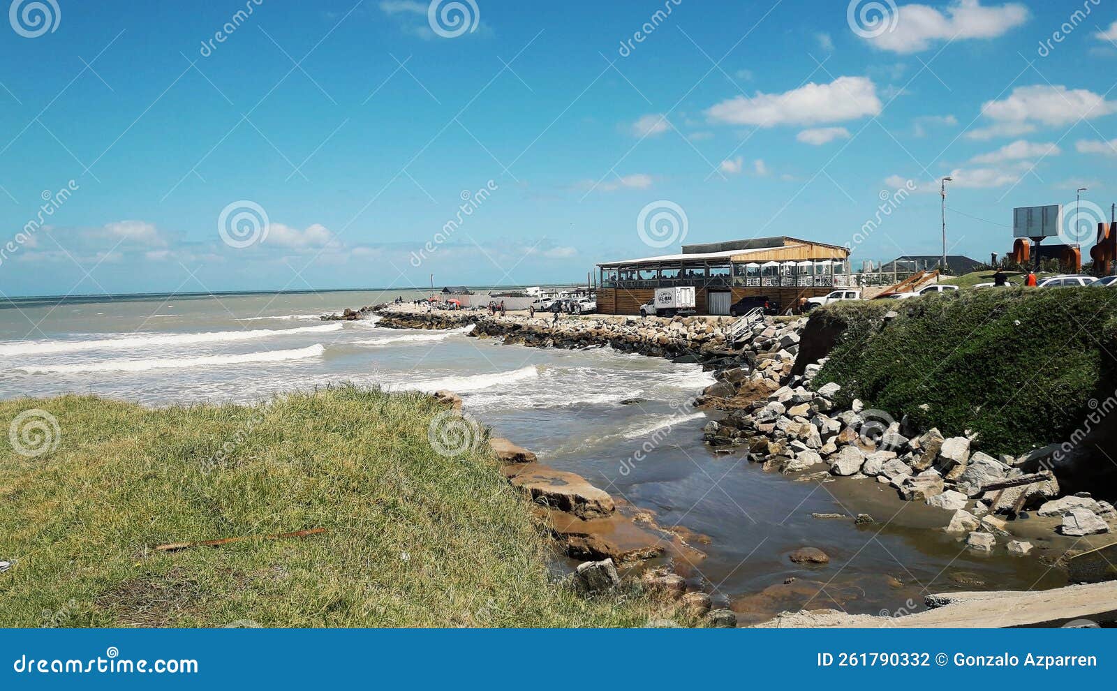 Rock Breakwater, Beach, Sea with Waves, Sky with Clouds Stock Photo ...