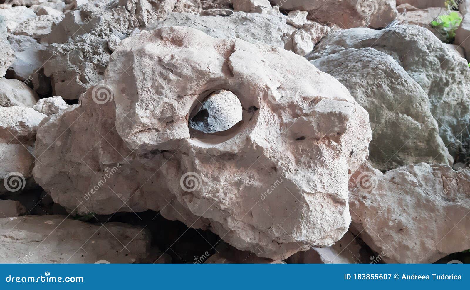 A rock with a round hole stock image. Image of hole - 183855607