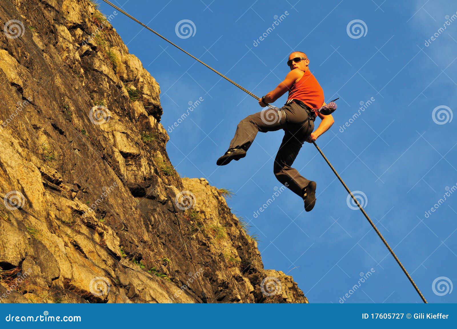Rock climber jumping stock image. Image of rock, gear - 17605727
