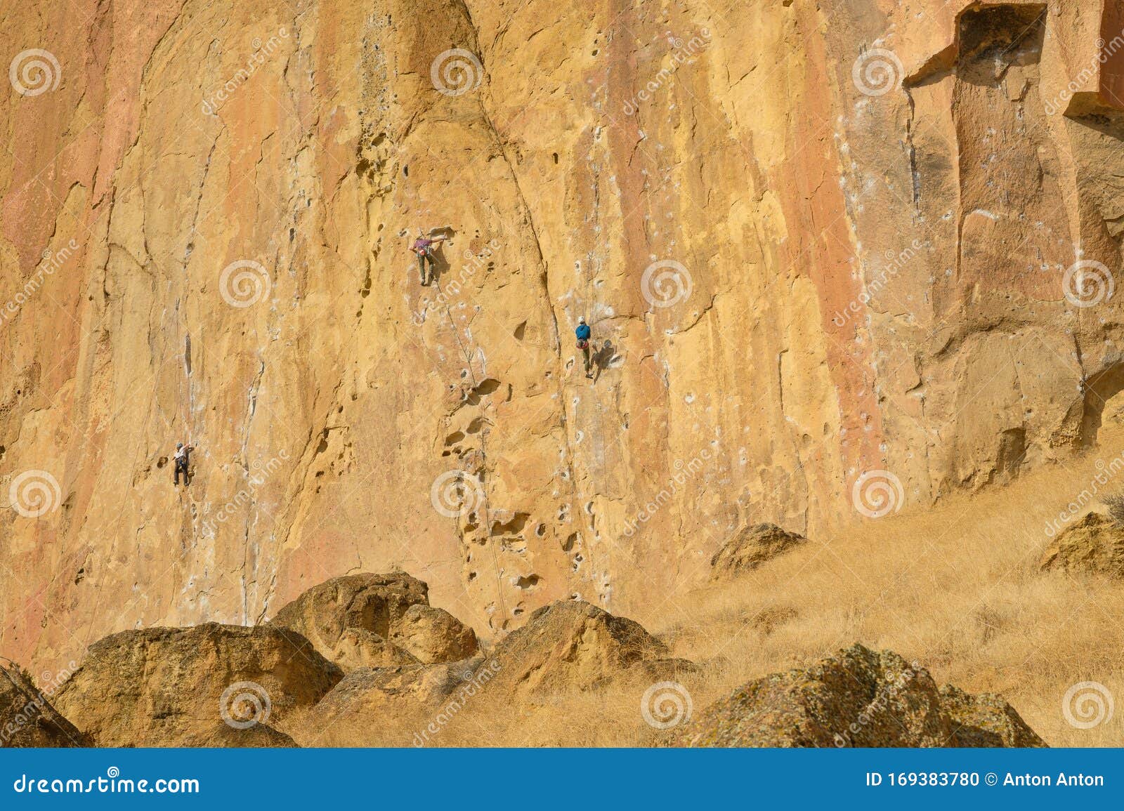 Climbers Climb The Tower In Daylight With A Blue Sky Background Stock ...