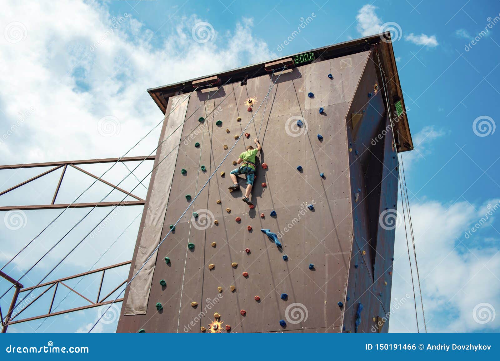 Rock Climbing on an Artificial Rise. the Boy Climbs on the Wall in an ...