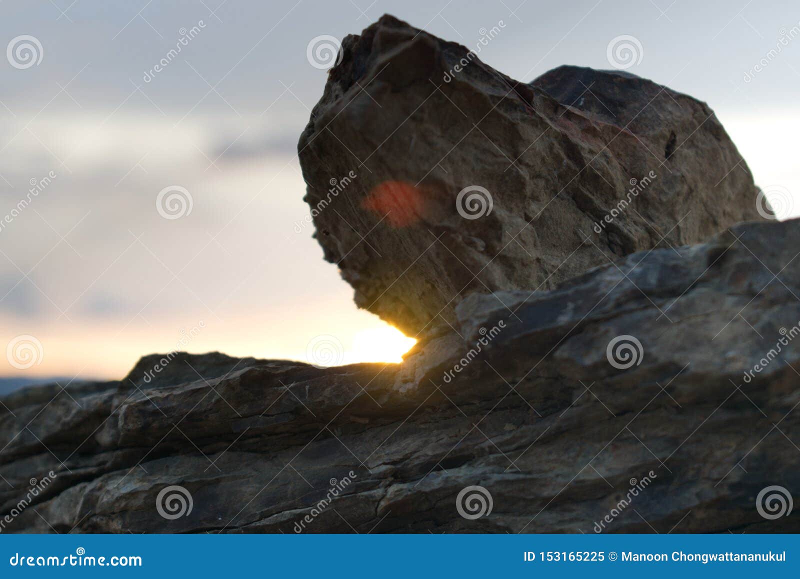 Rocks on a beach at sunset stock image. Image of coastline - 153165225