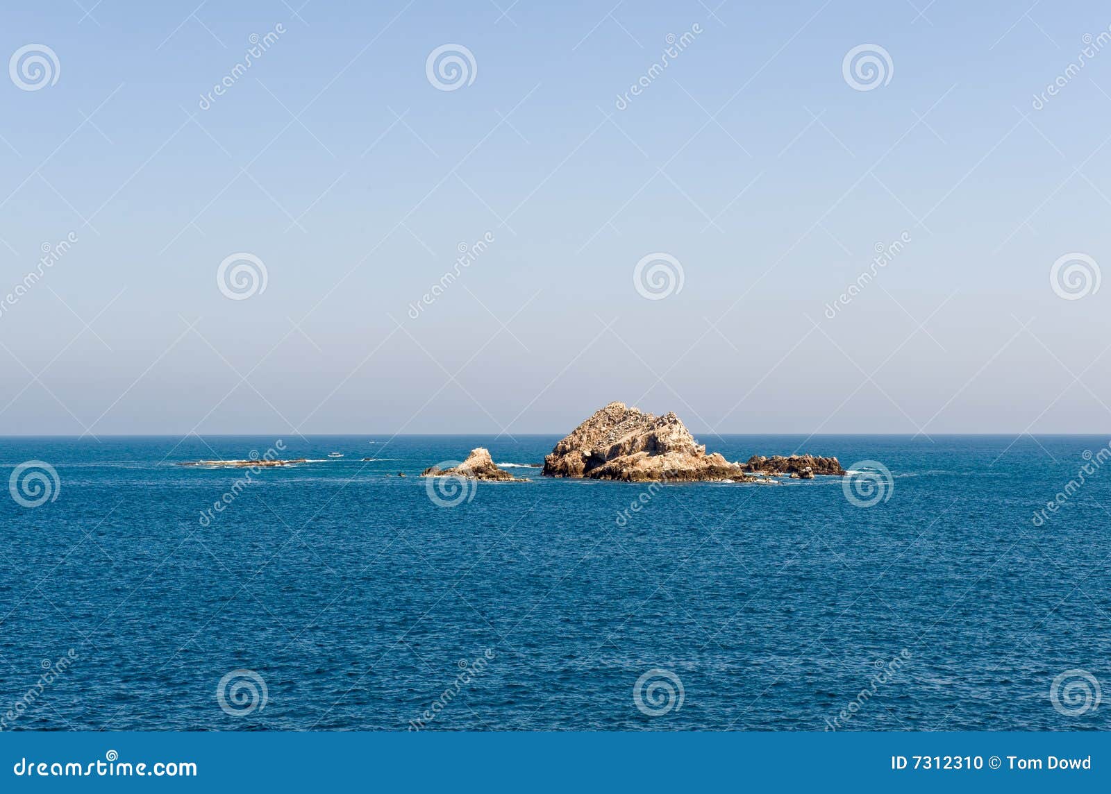 Rock formation in blue sea stock photo. Image of rock - 7312310