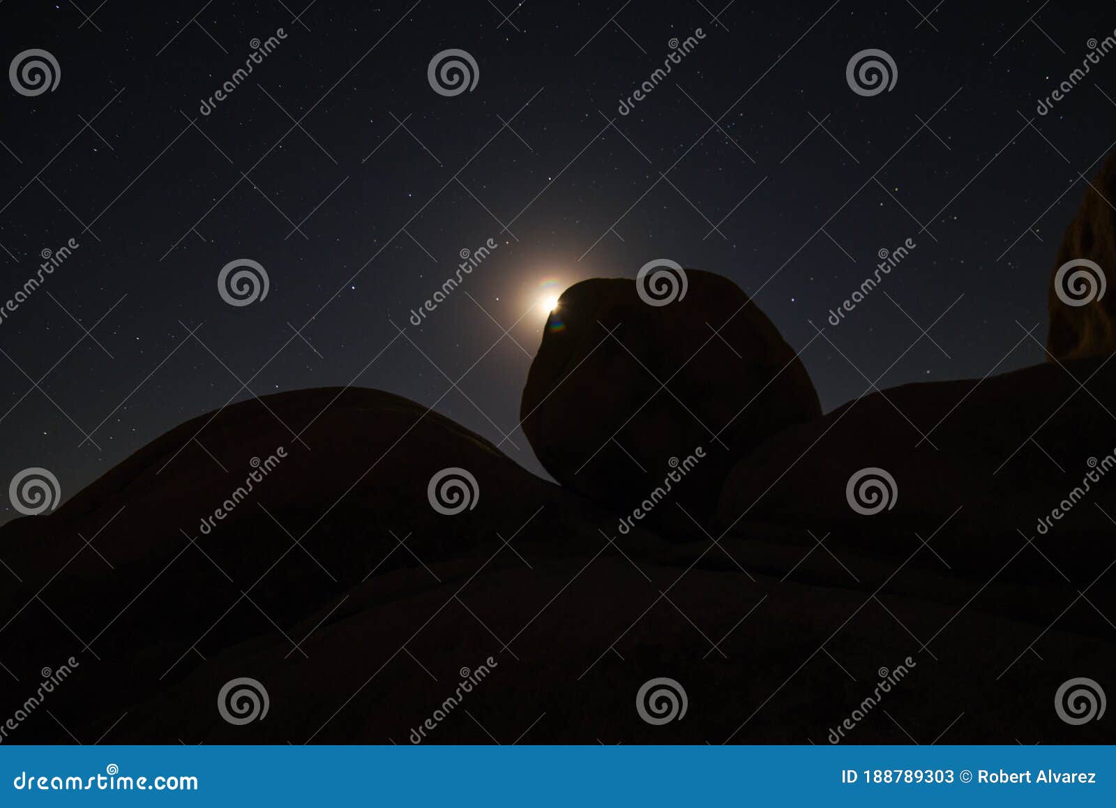A Rock Formation Eclipses the Moon Stock Image - Image of space, tree ...