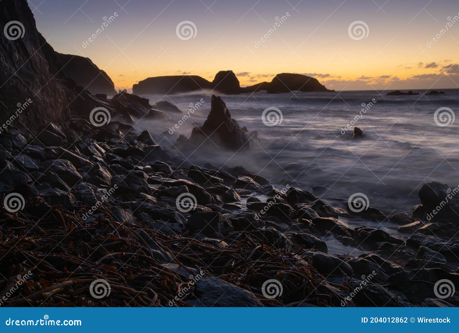 Rock Formations in the Foamy Water of the Sea at Sunset Stock Photo ...