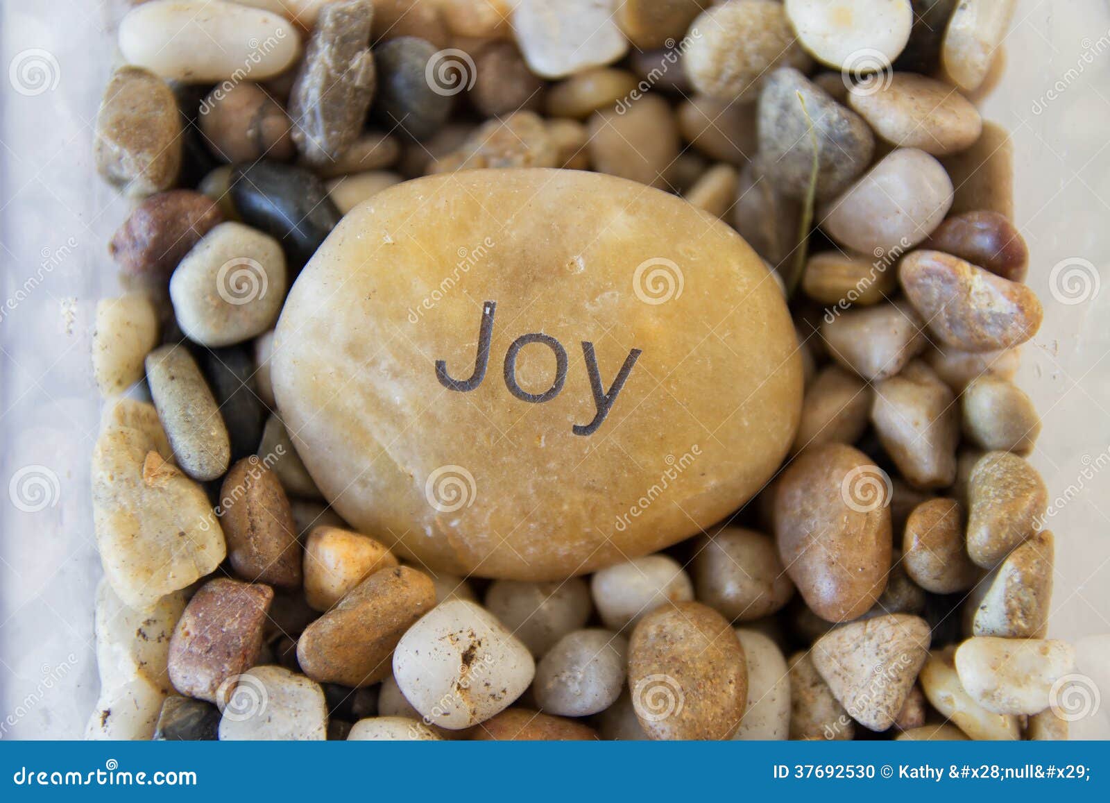 A Rock with Joy Engraved on it Stock Photo - Image of large, tones ...