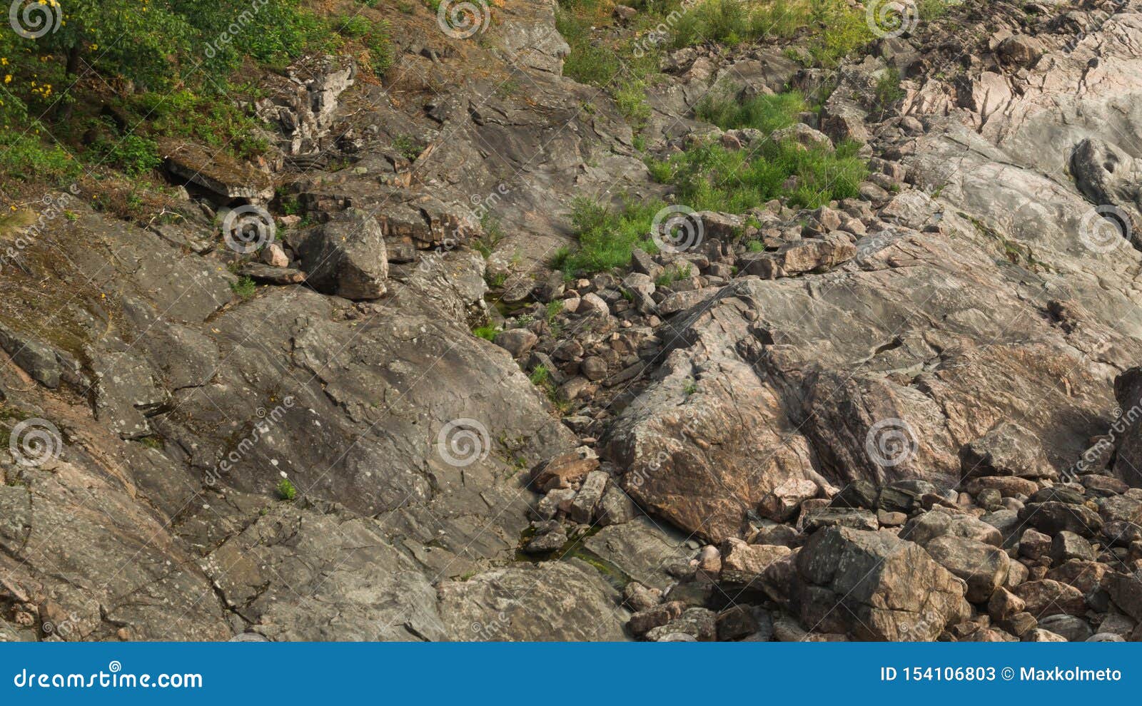 Rock of Layered Stone Overgrown with Grass and Moss. Texture of Stone ...