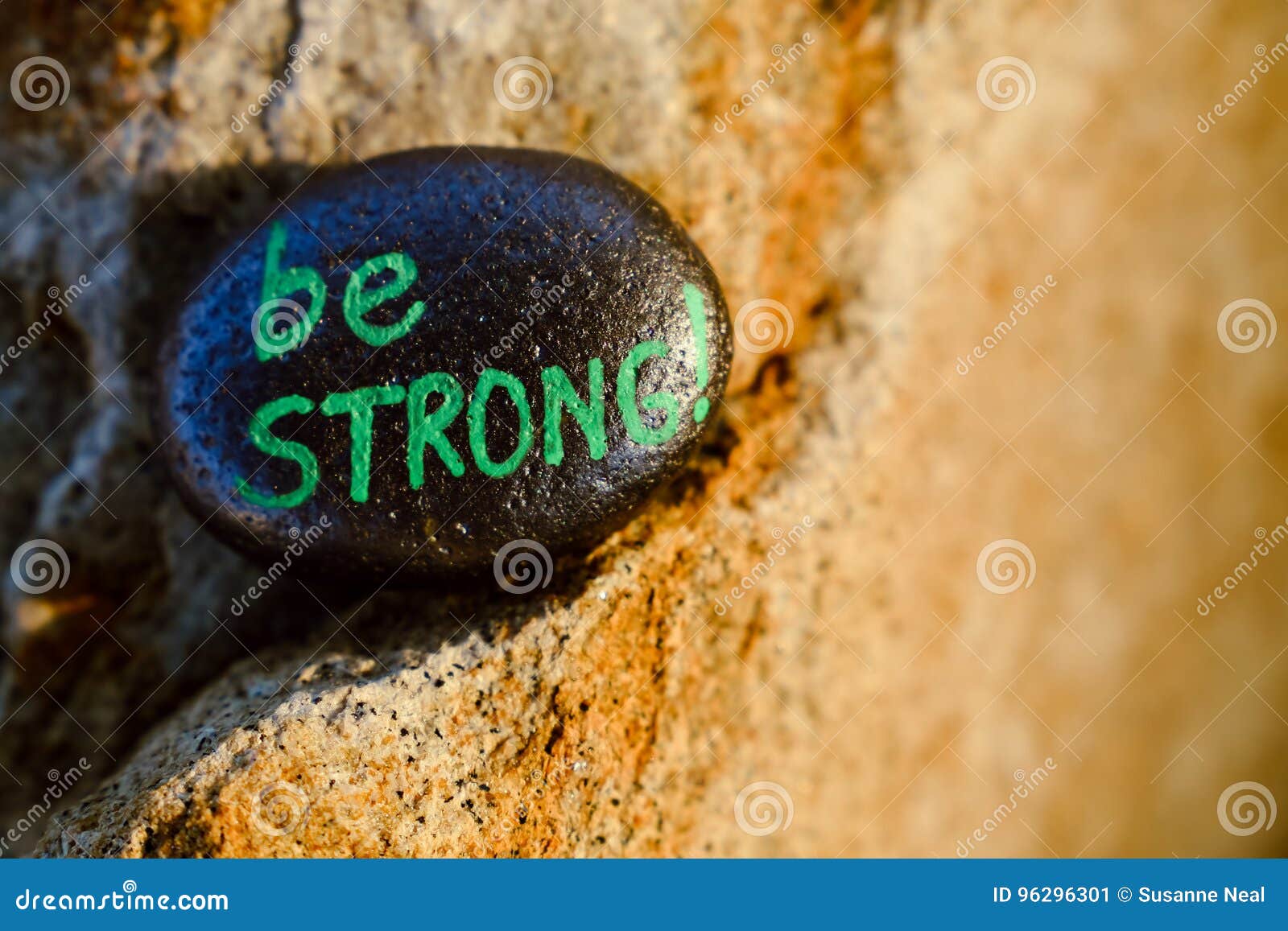A Rock Painted Black with the Message Be STRONG Stock Image - Image of ...
