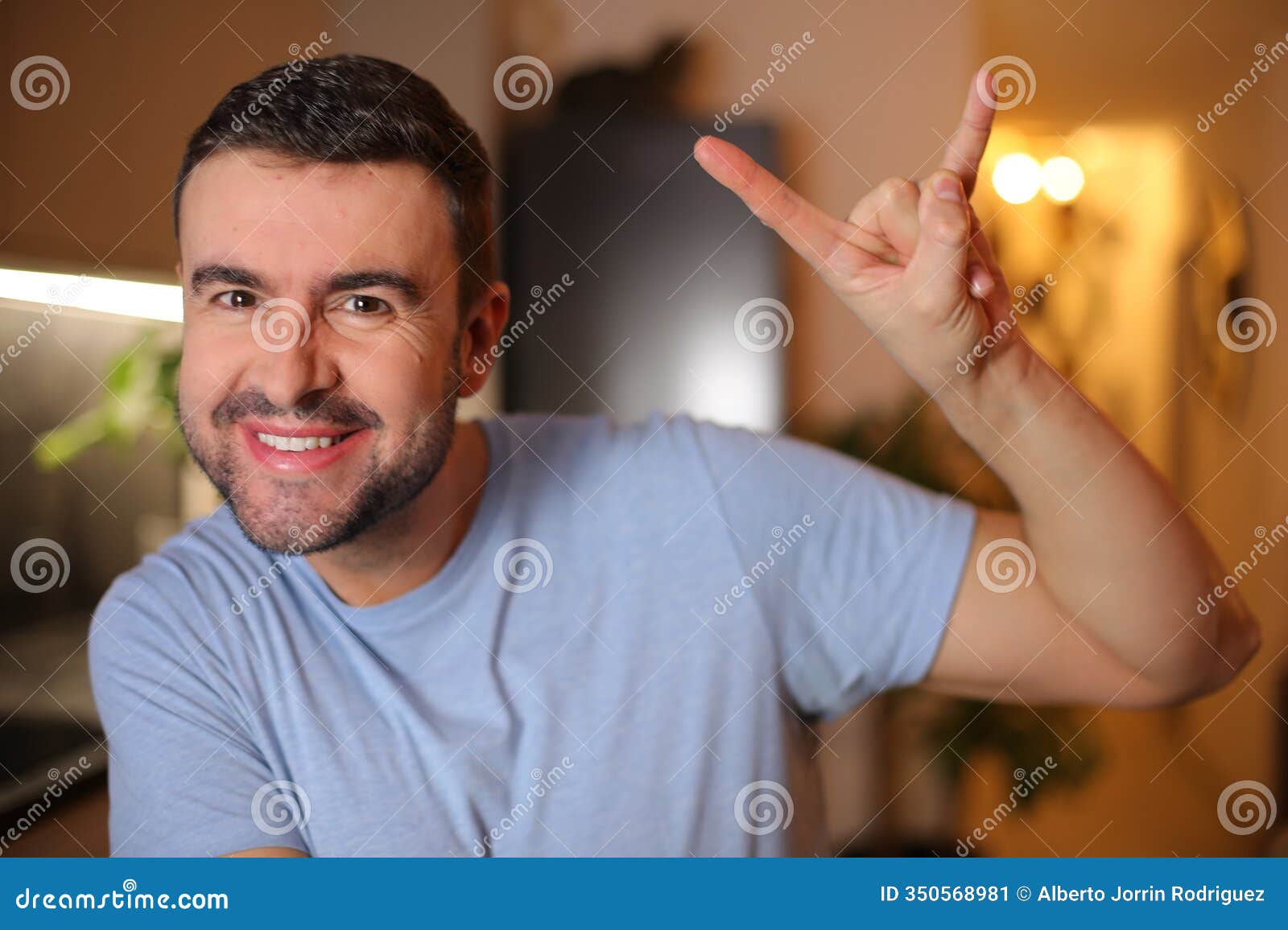 Rock and Roll Fan Doing the "Rock on" Hand Gesture To Show Approval ...