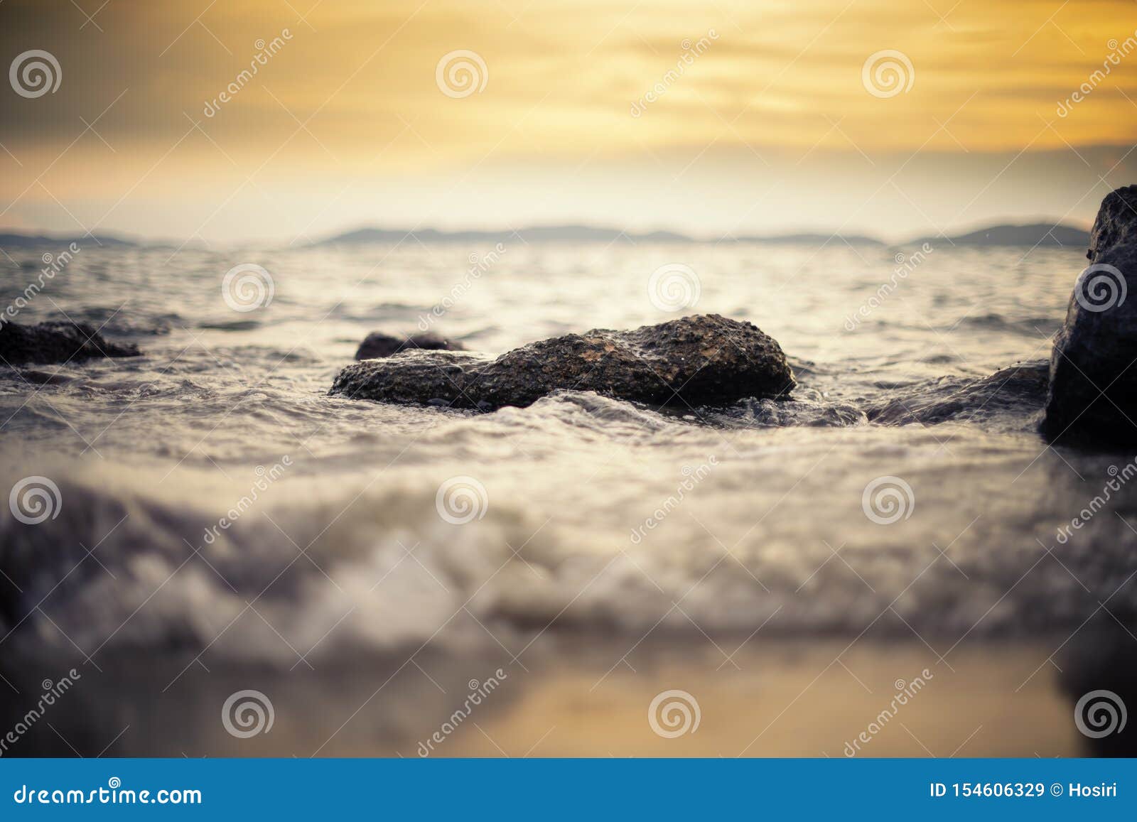 The rock in the sea wave stock image. Image of evening - 154606329