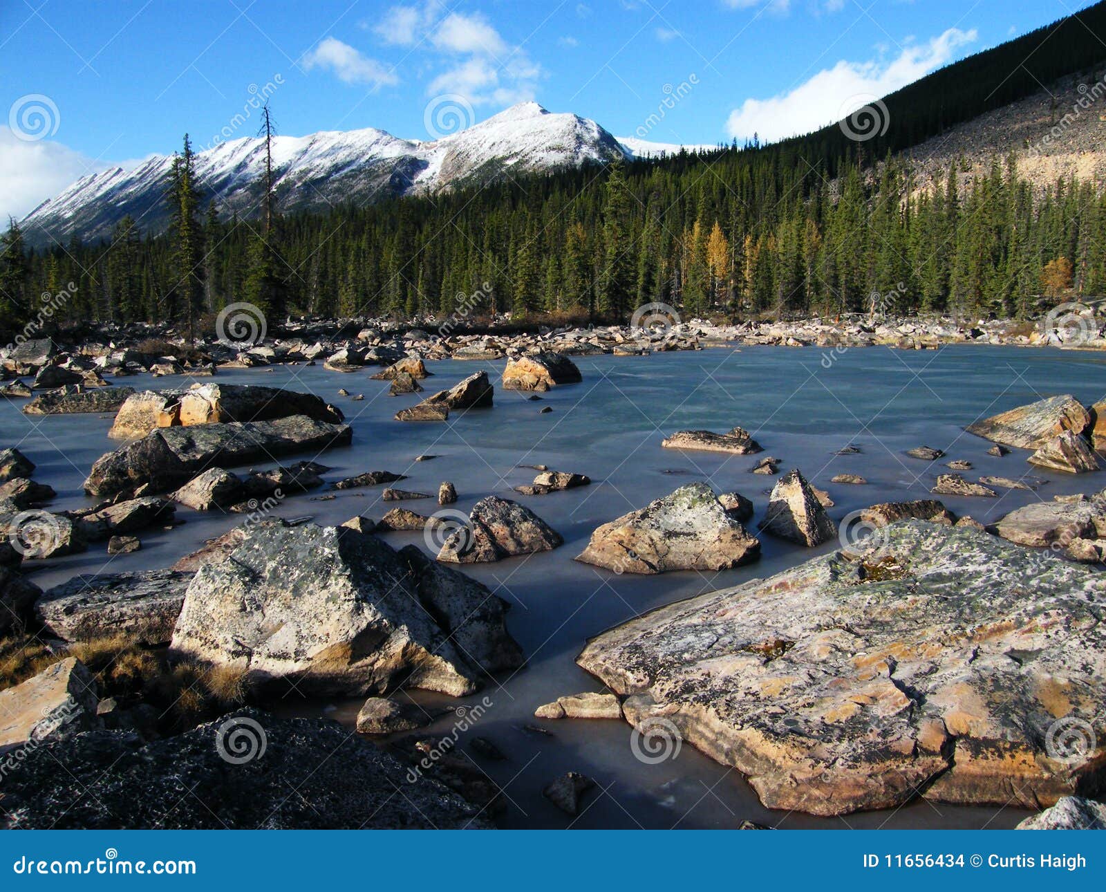 Rock slide on frozen lake stock photo. Image of jasper - 11656434
