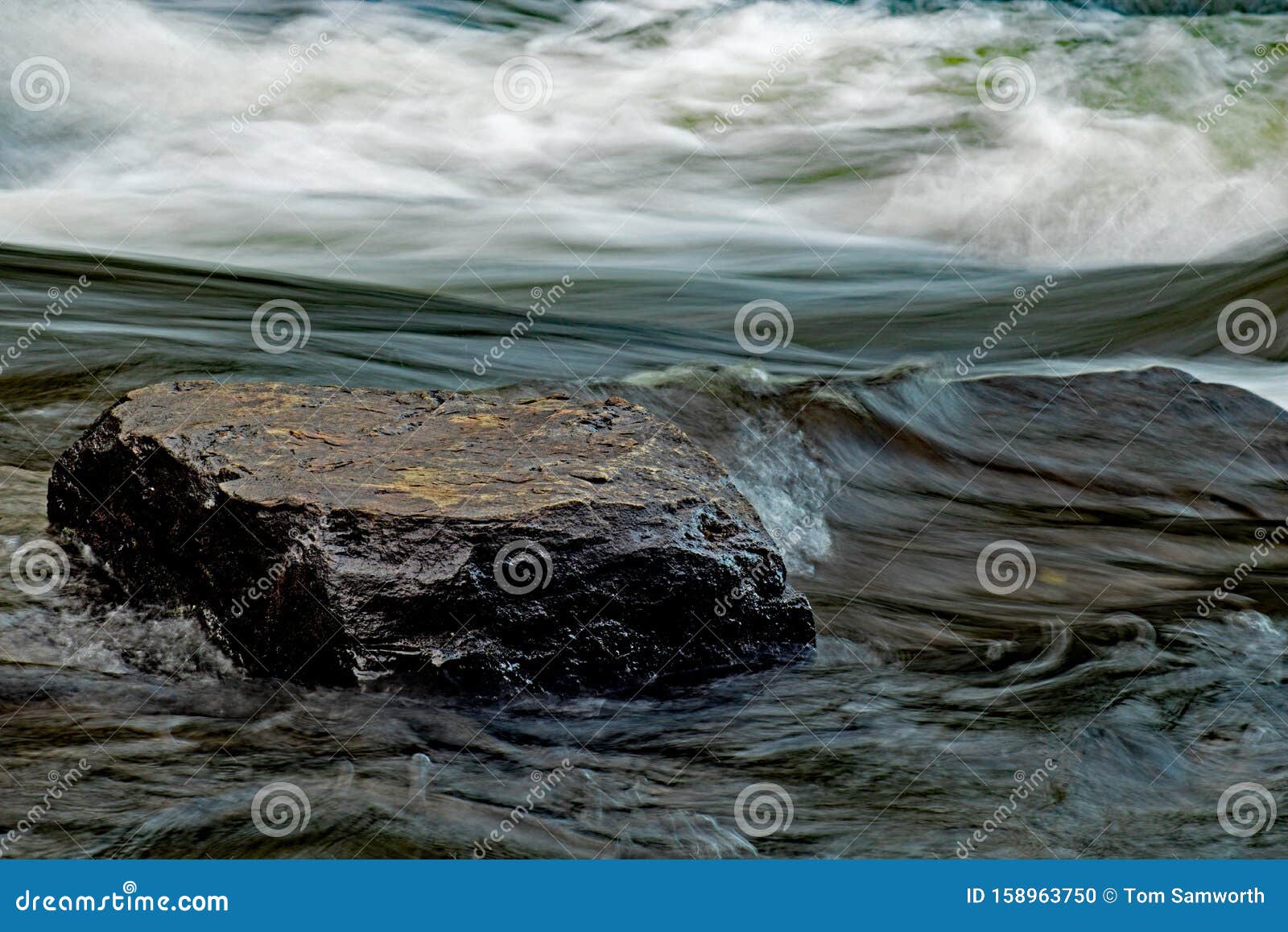 Rock Stands Solid in a Powerful Current Stock Photo - Image of leveled ...