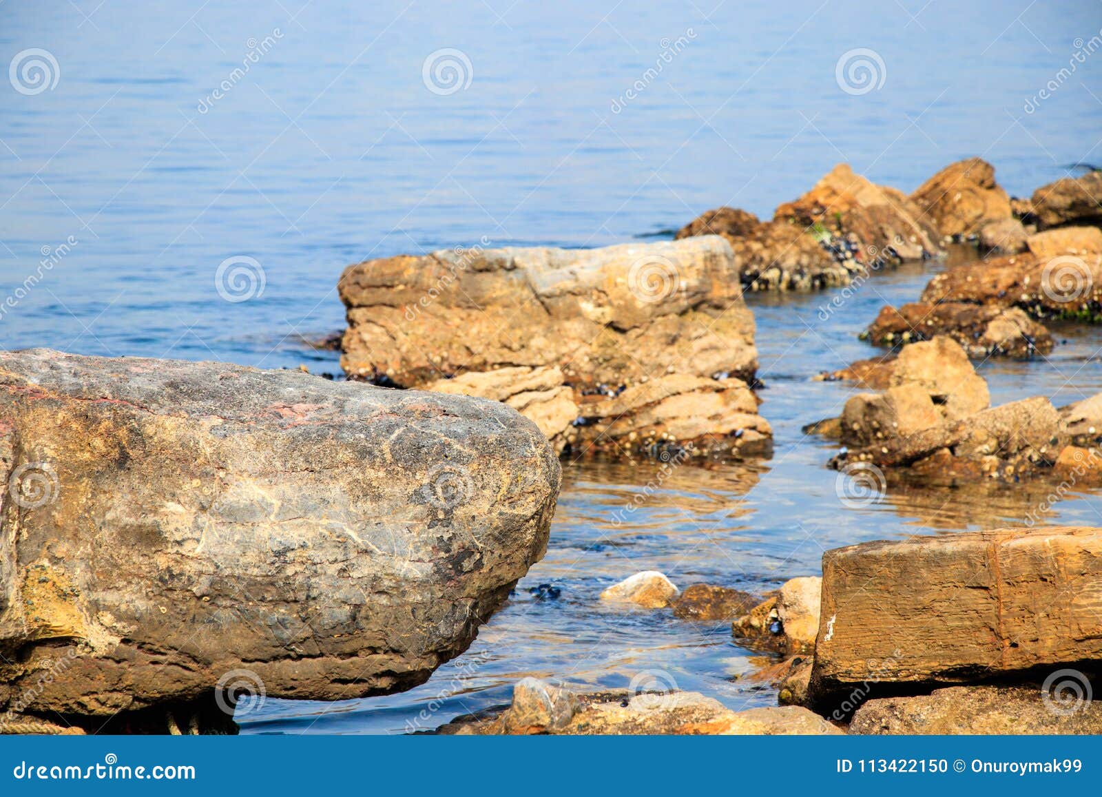 Rock stone in blue sea stock photo. Image of sand, nature - 113422150