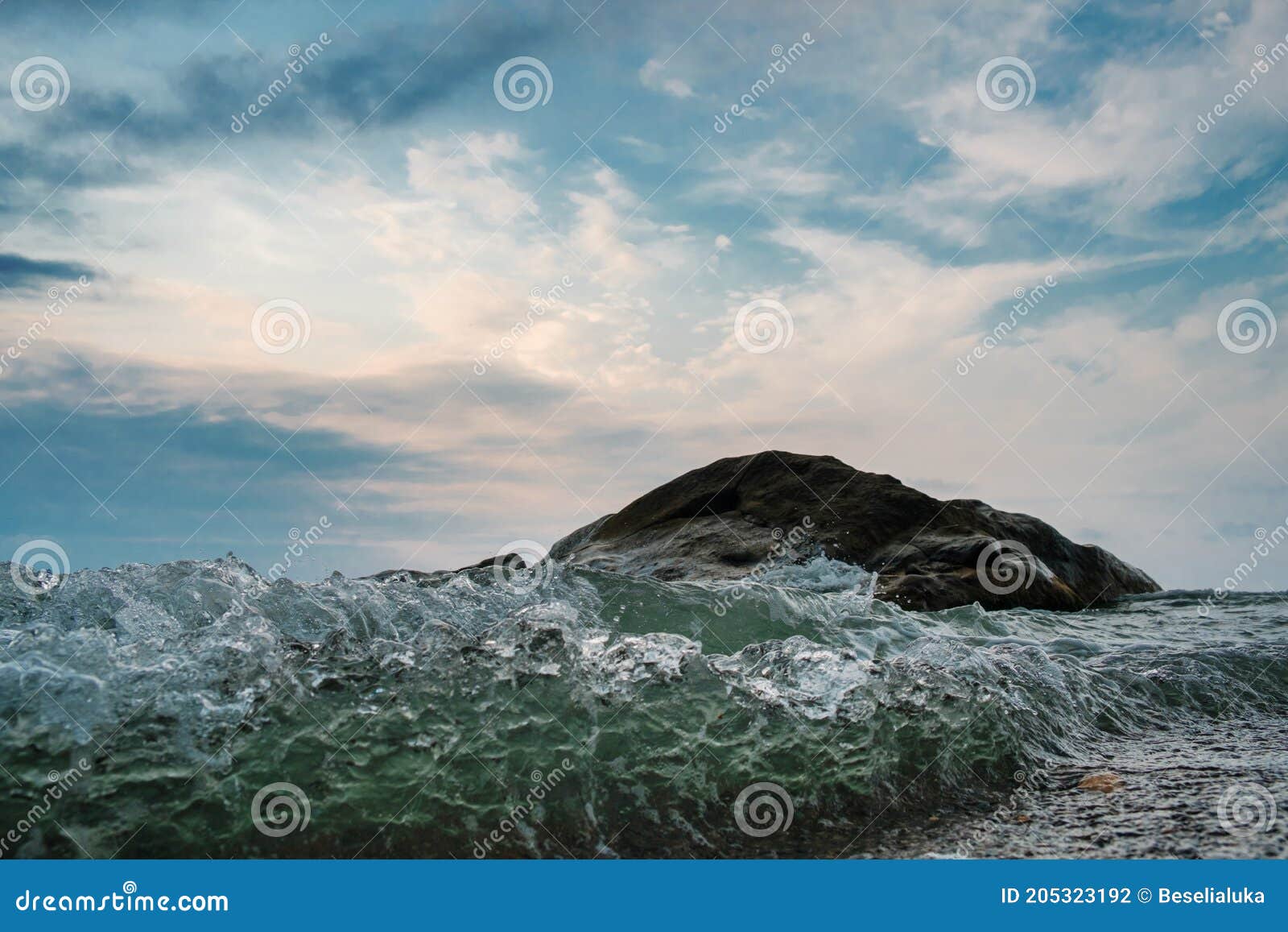 A Rock Surrounded by Sea Waves Stock Photo - Image of seashore ...