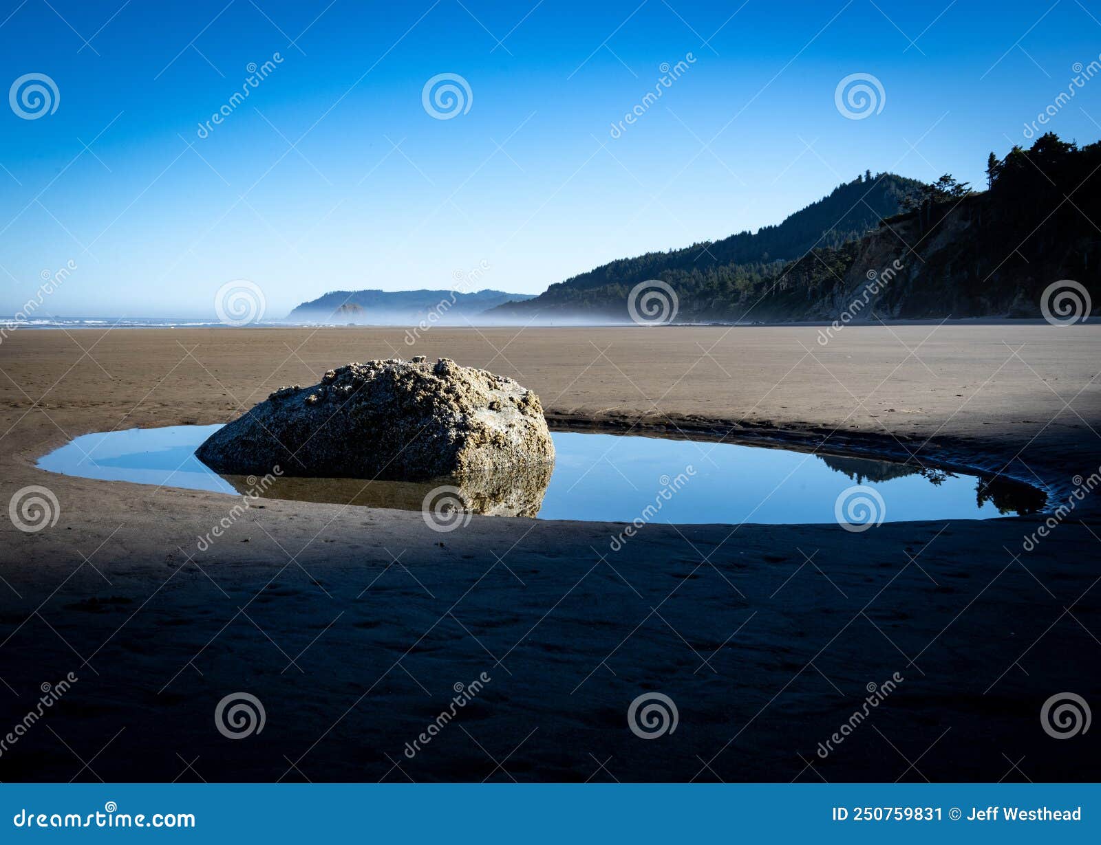 Rock in Tide Pool with View Down the Beach at Hug Point in Oregon Stock ...