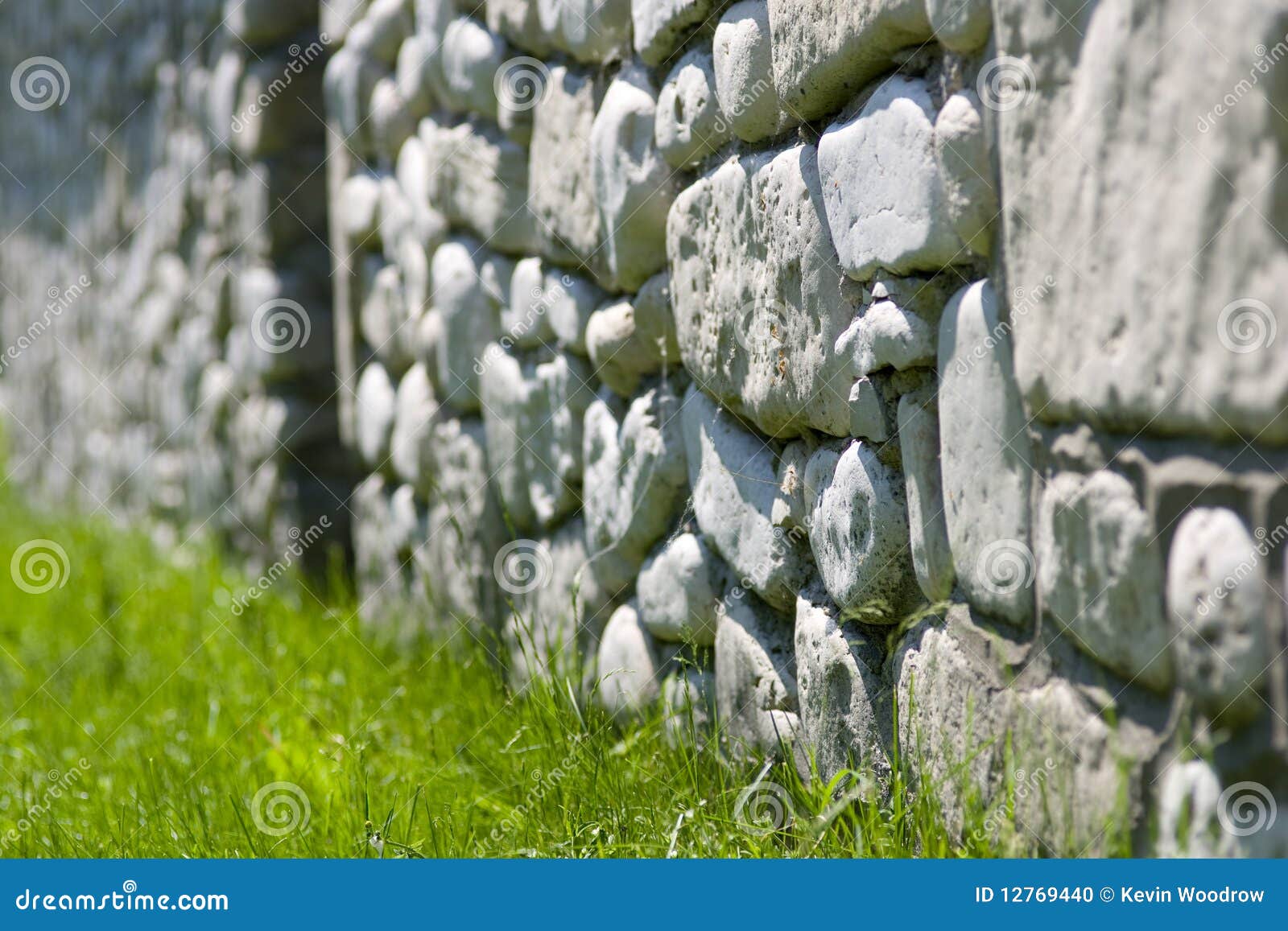 Rock Wall Against Green Grass Stock Photo - Image of texture, gray ...
