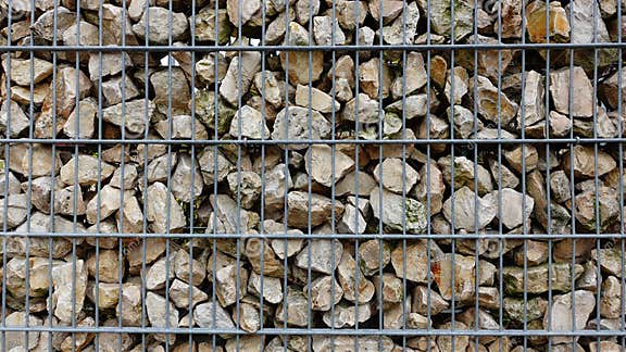 Rock Wall Construction Using Wire Mesh for Landscaping and Design Stock ...