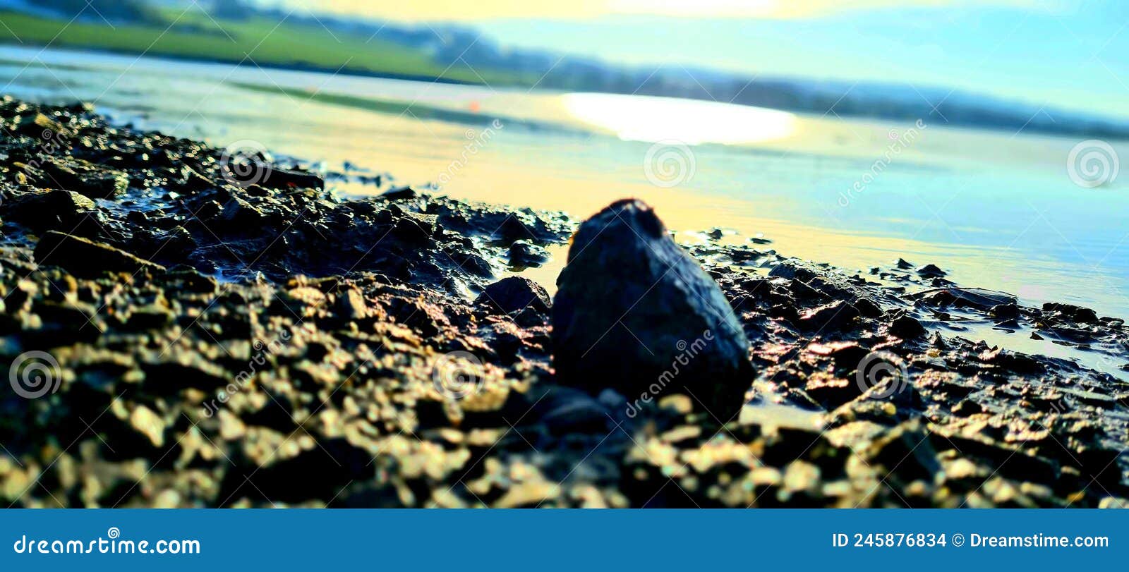 Rock on Water 2021 stock photo. Image of cloud, shore - 245876834