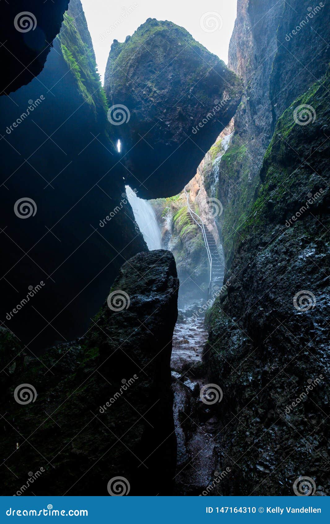 Rock Wedged Above Water Fall Stock Photo - Image of cave, steps: 147164310