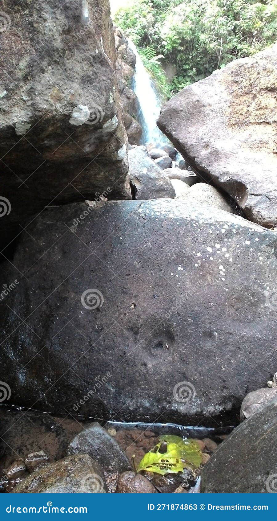 A Rock through Which Water Flowing from the Mountain Passes. Stock ...