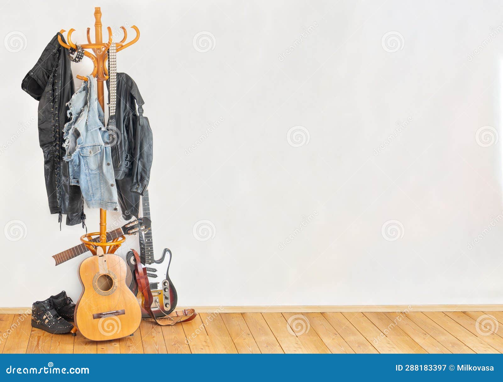 The Rocker S Clothes Hanging on a Hanger with Guitar on a Floor Stock ...