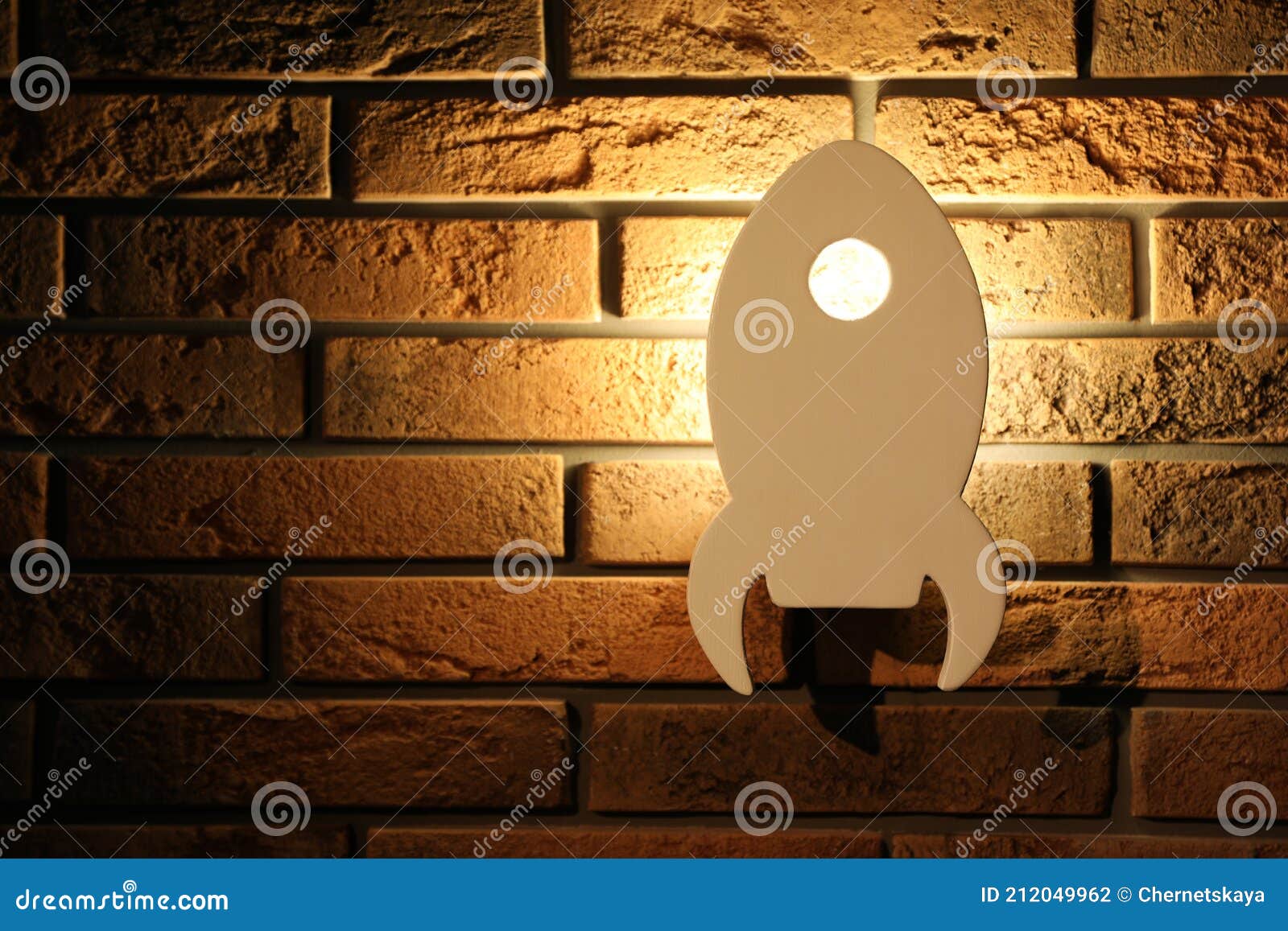 Rocket Shaped Night Lamp on Brick Wall. Space for Text Stock Photo ...
