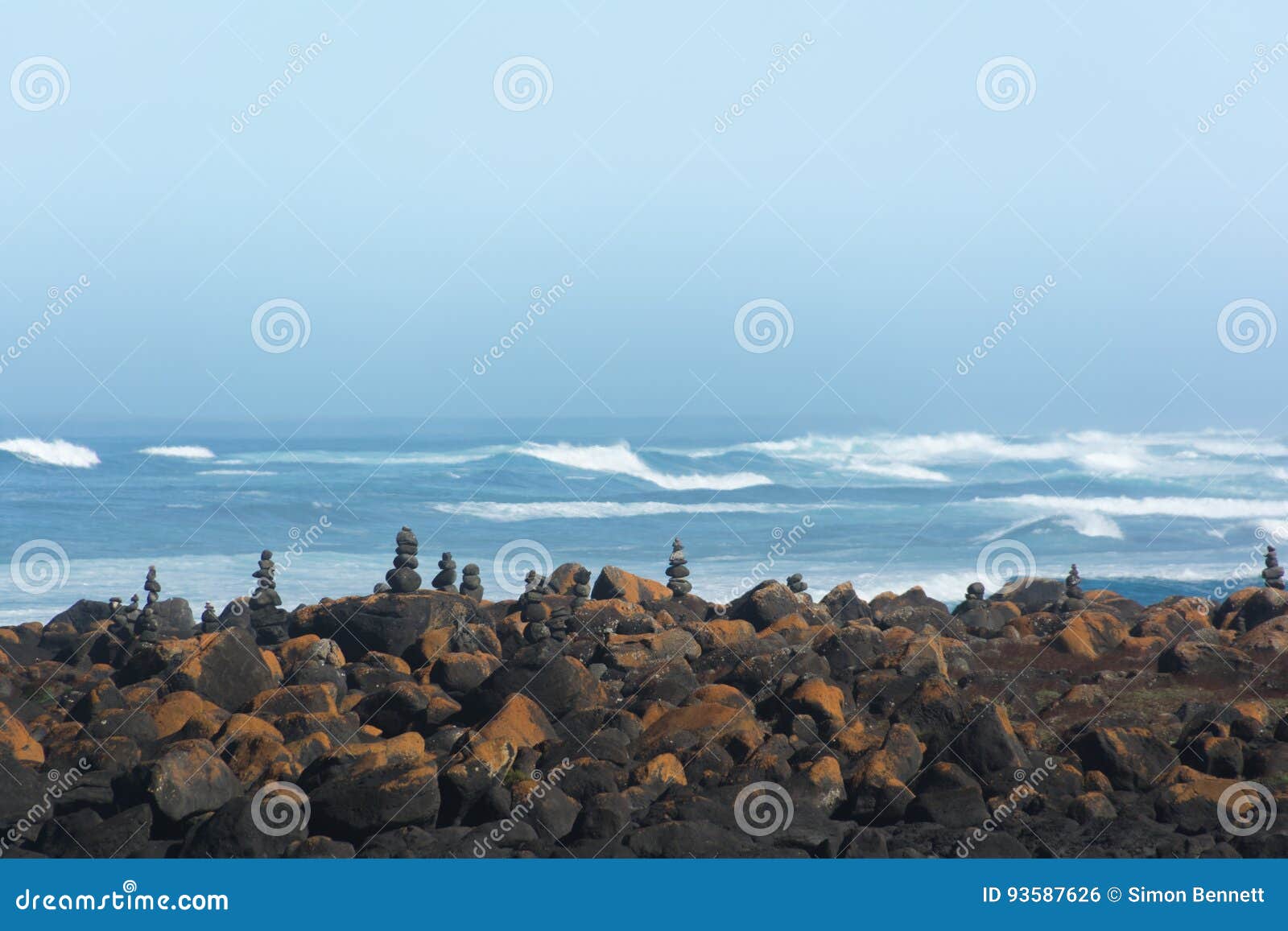 Rocks Balancing in Stack on a Stone Covered Beach with Ocean Behind ...