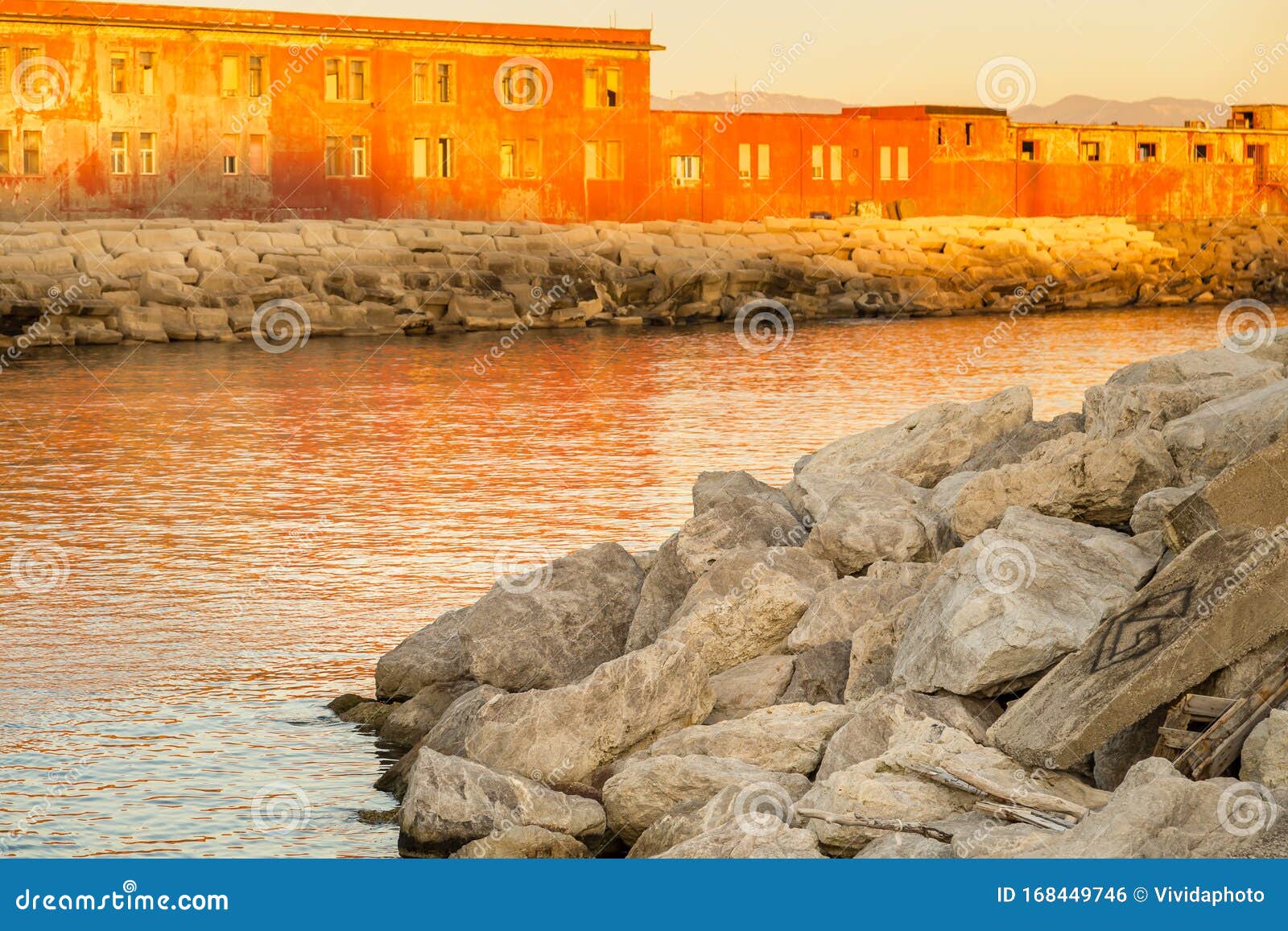 Rocks on bay stock photo. Image of italy, rocks, buildings - 168449746