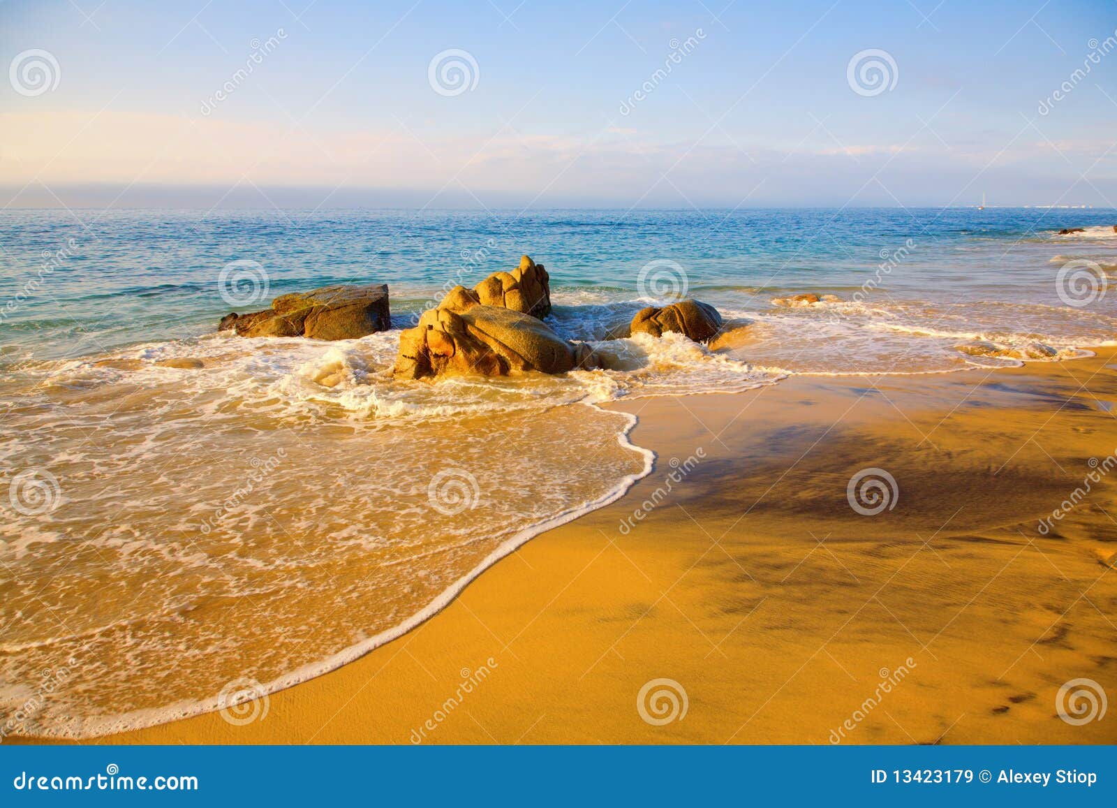 Rocks on the beach stock image. Image of blue, sand, horizon - 13423179