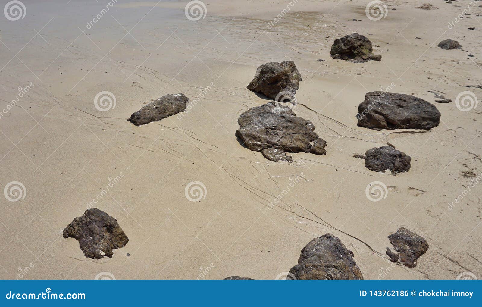 Rocks on the beach stock photo. Image of sand, stone - 143762186