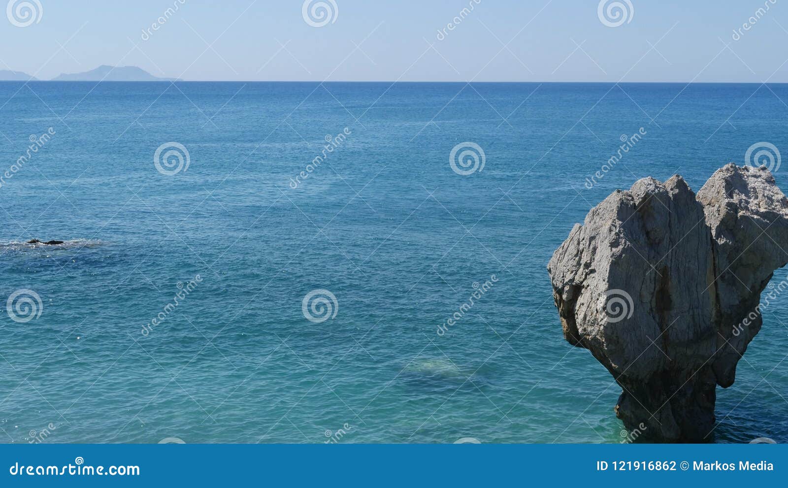 Rocks in Deep Blue Sea stock photo. Image of garden - 121916862