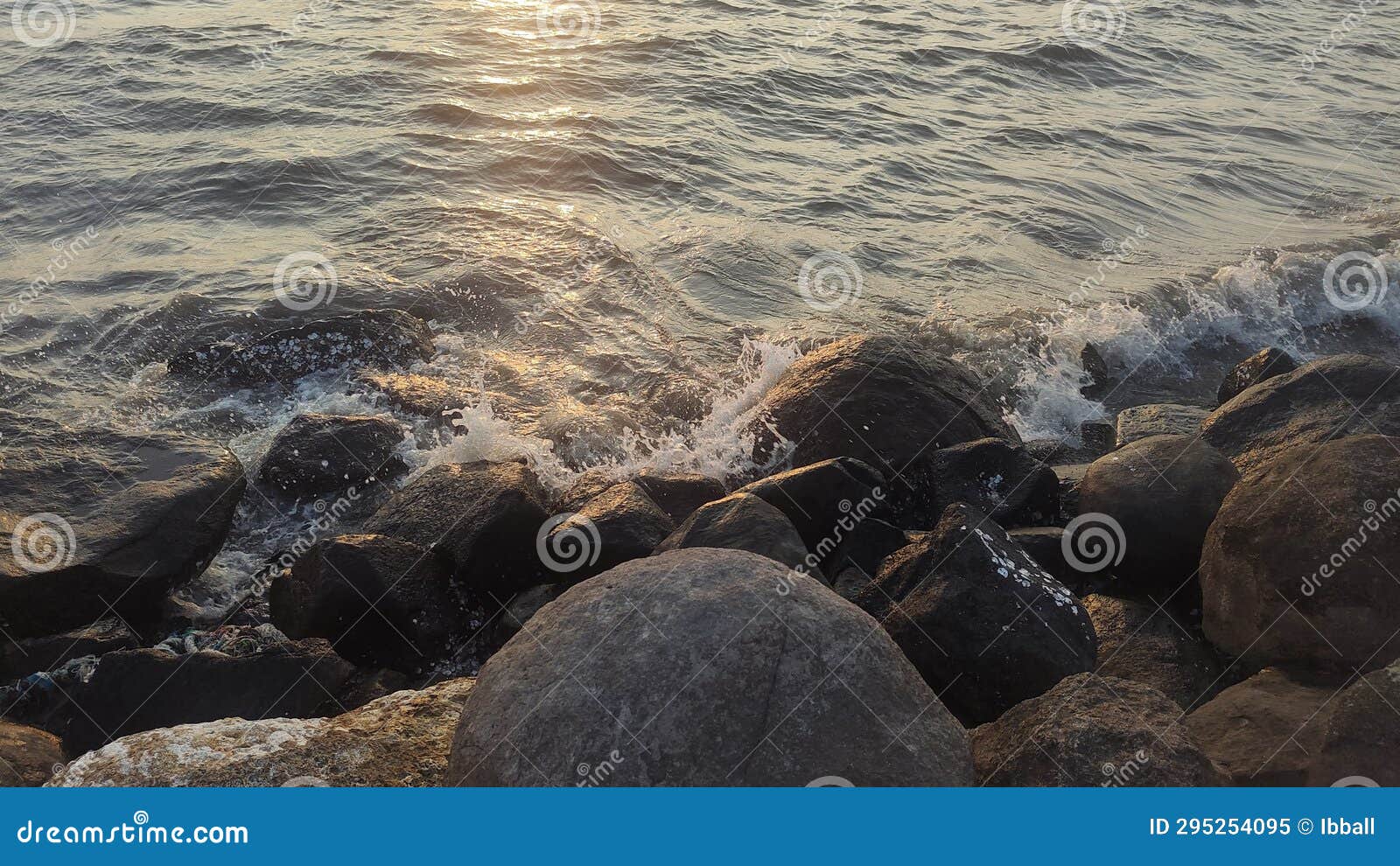 Rocks hit by waves stock image. Image of sunset, nature - 295254095
