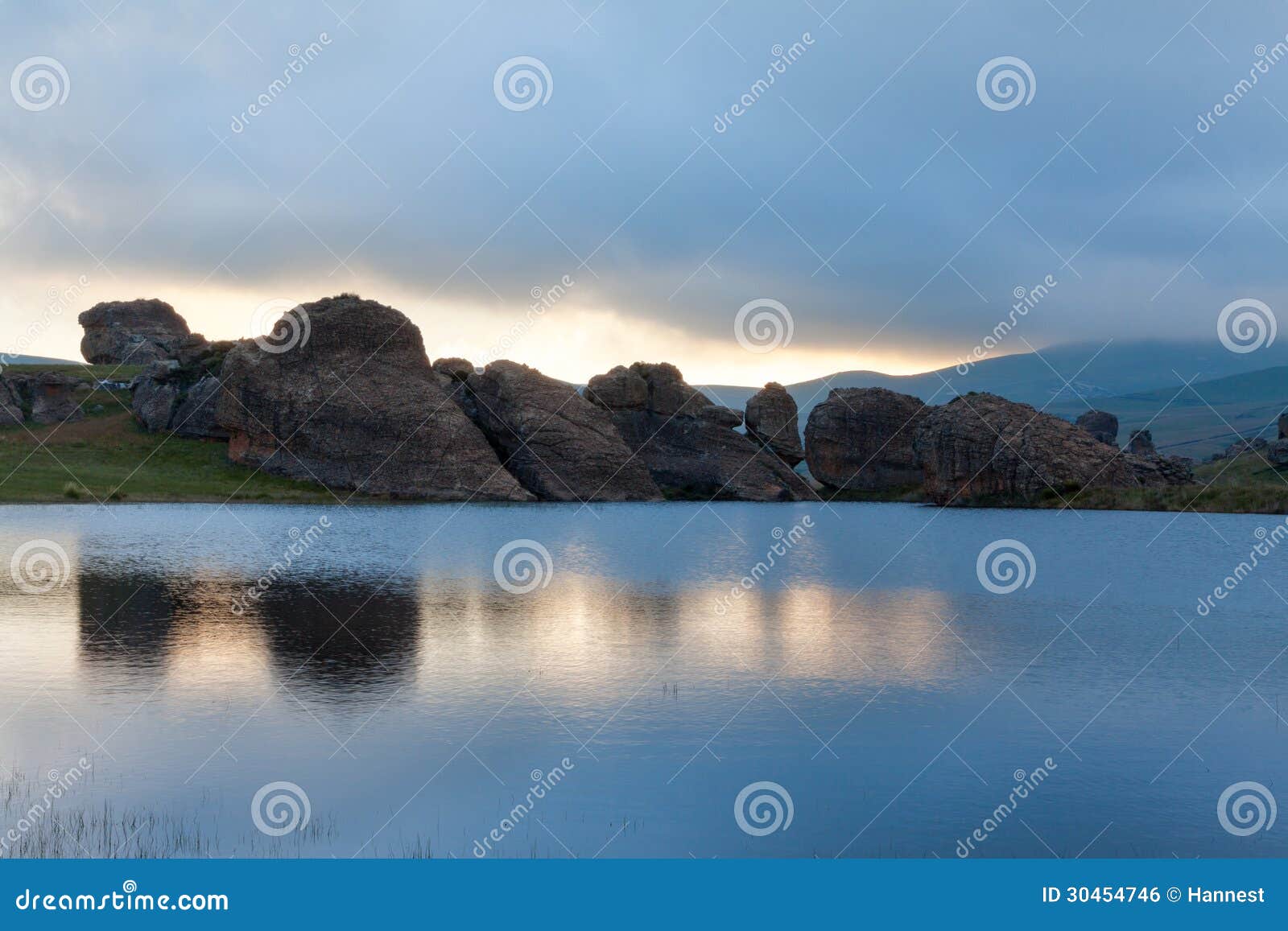 Rocks Reflecting in the Water Stock Photo - Image of outdoor, clouds ...