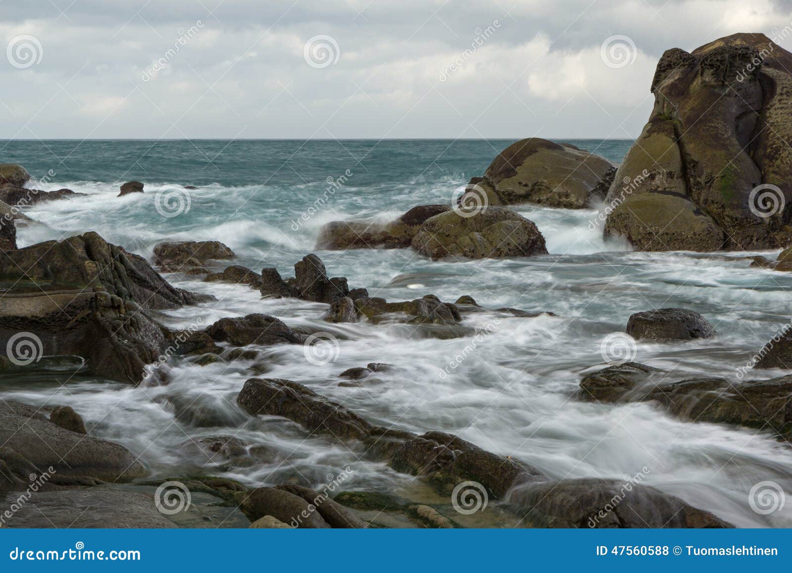 Rocks and restless ocean stock photo. Image of overcast - 47560588