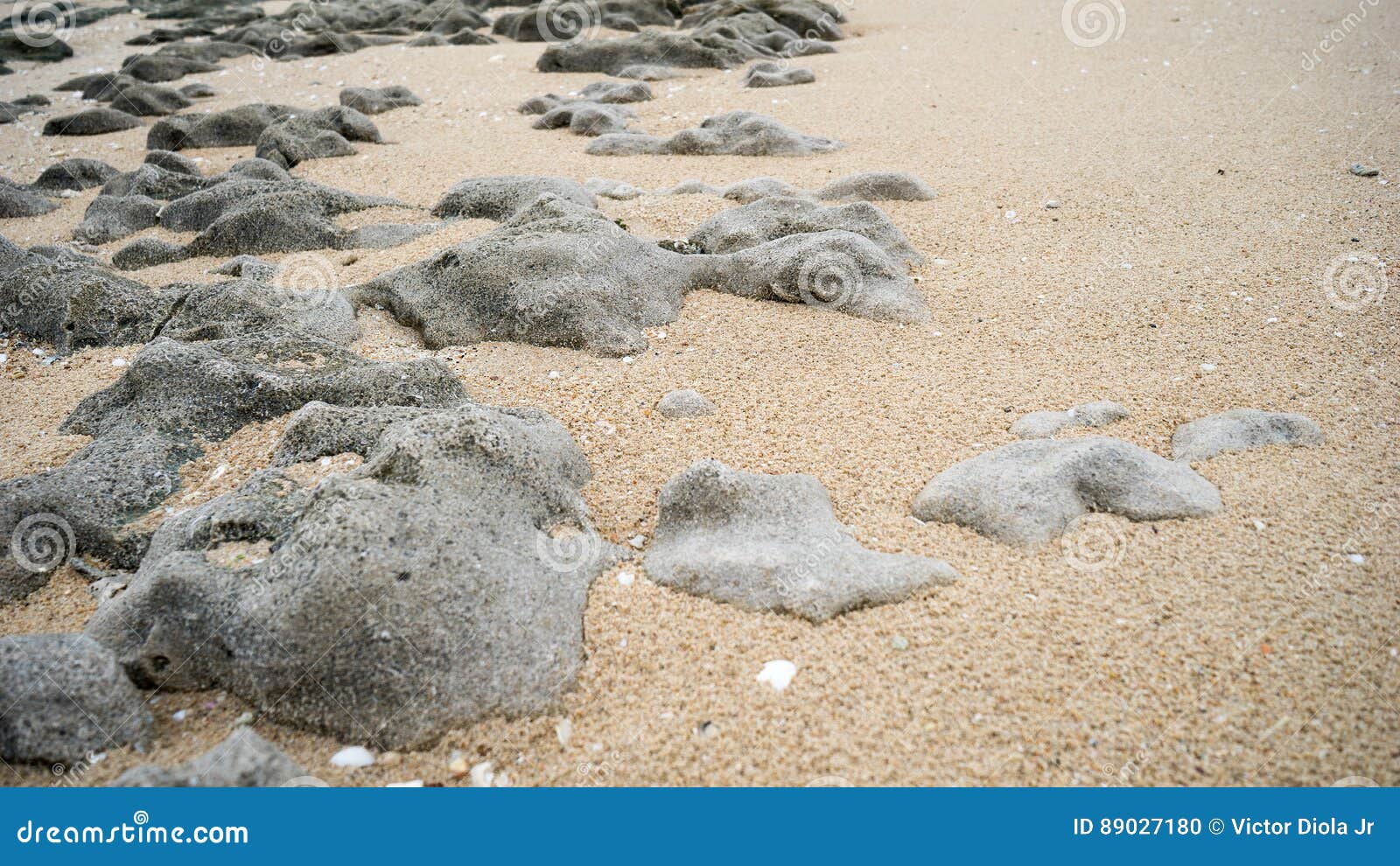 Rocks and Sand on Beach stock photo. Image of pebbles - 89027180