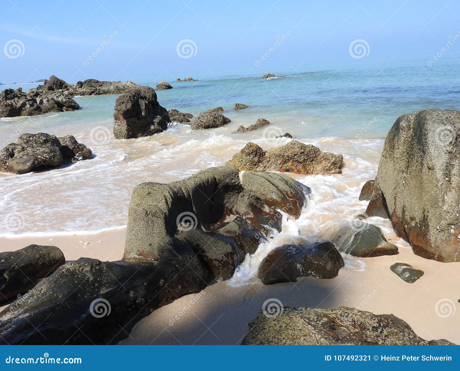 Rocks on the sandy beach stock image. Image of mountains - 107492321