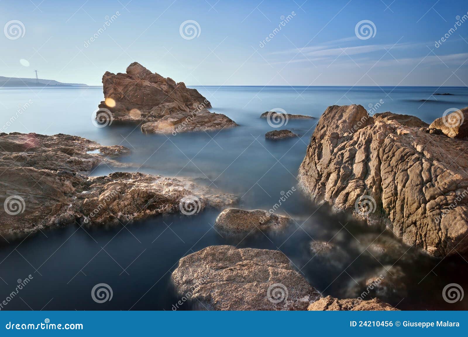 Rocks on the sea smooth. stock photo. Image of cloud - 24210456