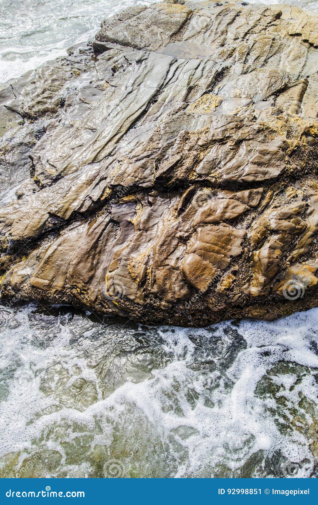 Rocks in shallow water. stock image. Image of larger - 92998851